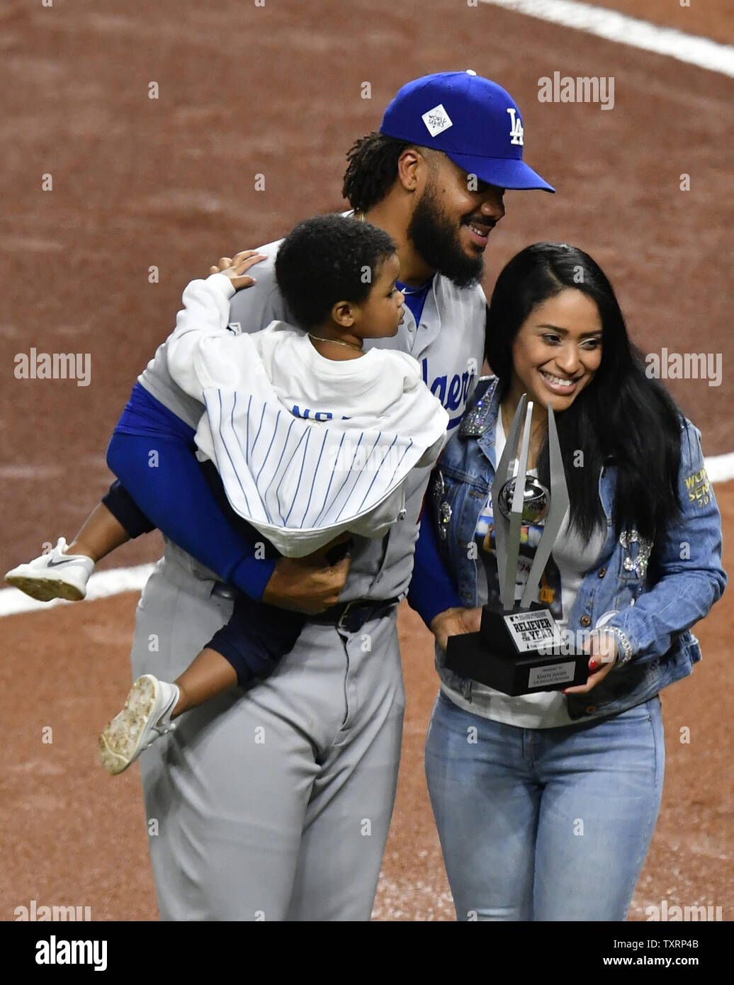 Los Angeles Dodgers reliever Kenley Jansen carries his daughter Natalia ...