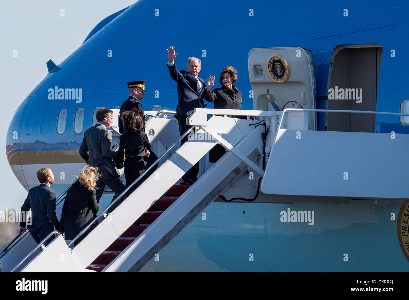 President George W. Bush and former first lady Laura Bush wave while ...