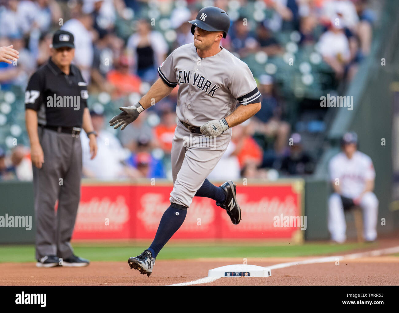 Brett Gardner of the New York Yankees rounds third base after hitting a ...