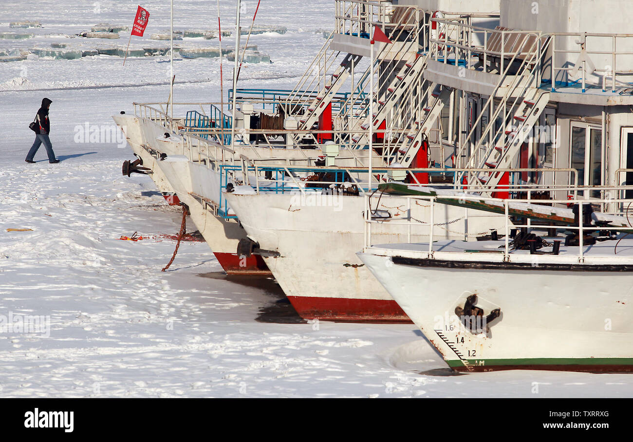 Tourist ships remain parked in a frozen river in Harbin, the capital of ...