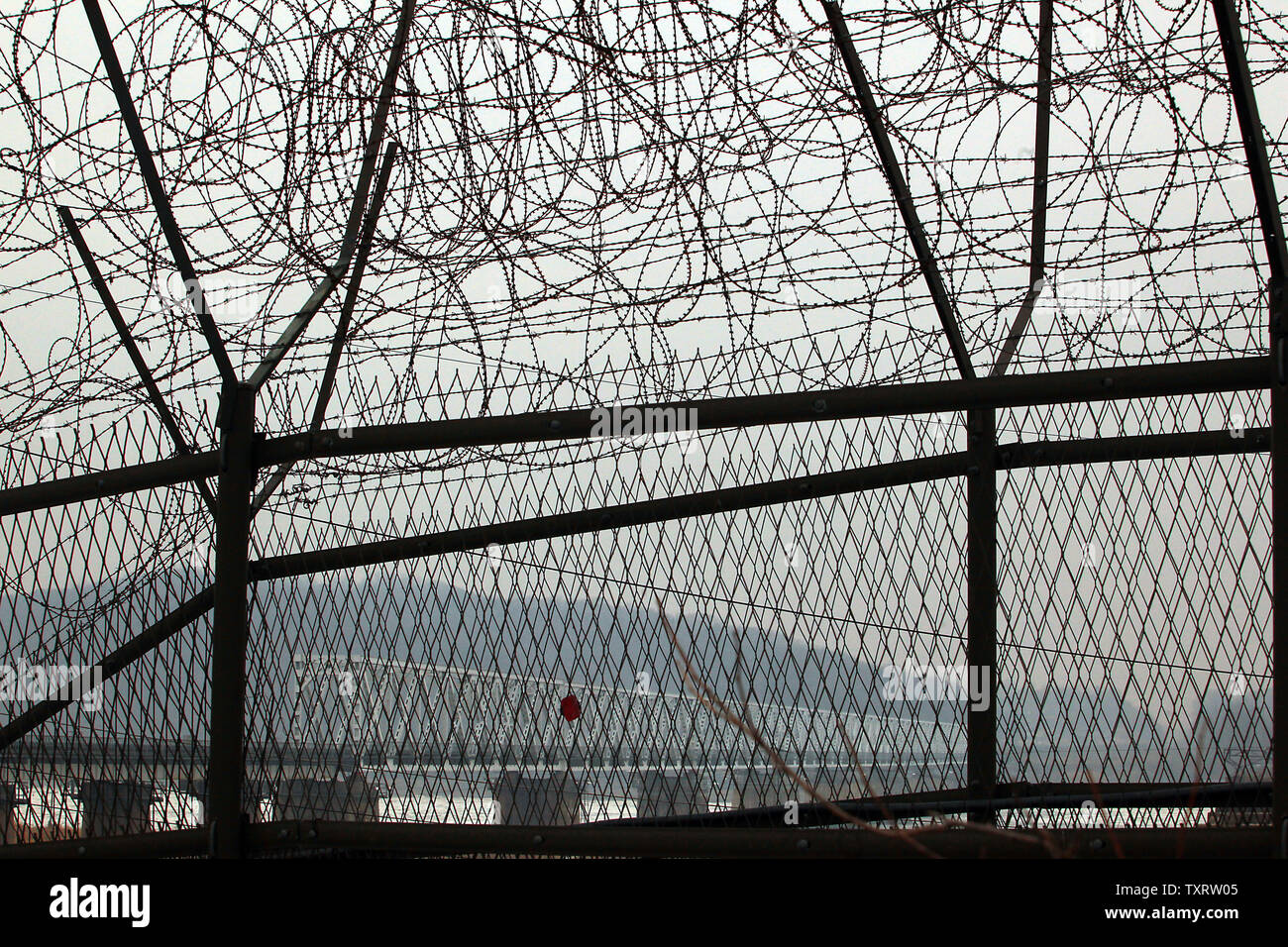 A barbed wire fence guards the Freedom Bridge which connects South ...