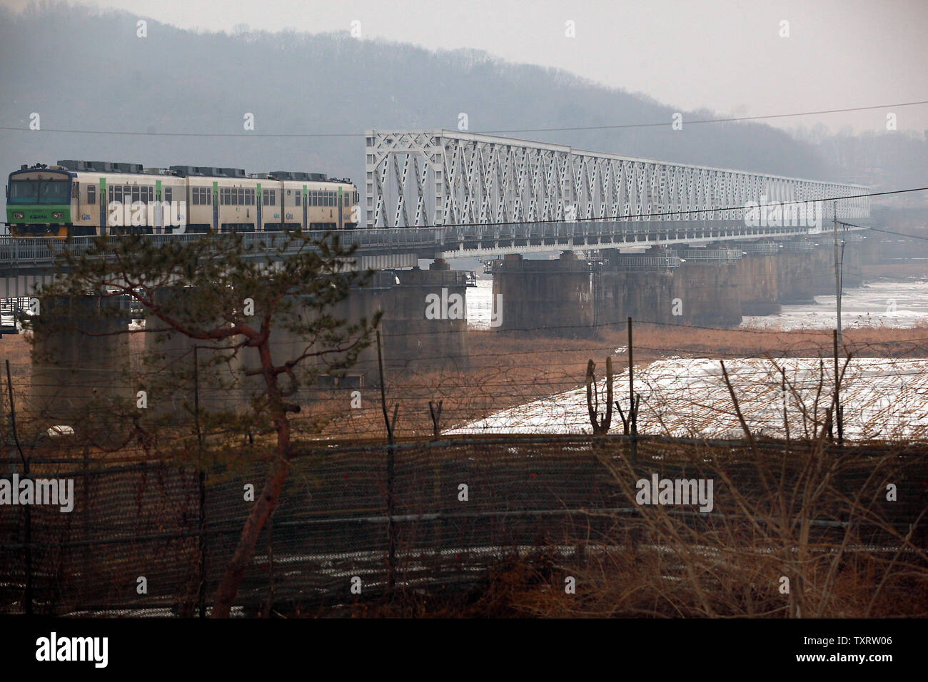A barbed wire fence guards the Freedom Bridge, connecting South Korea ...