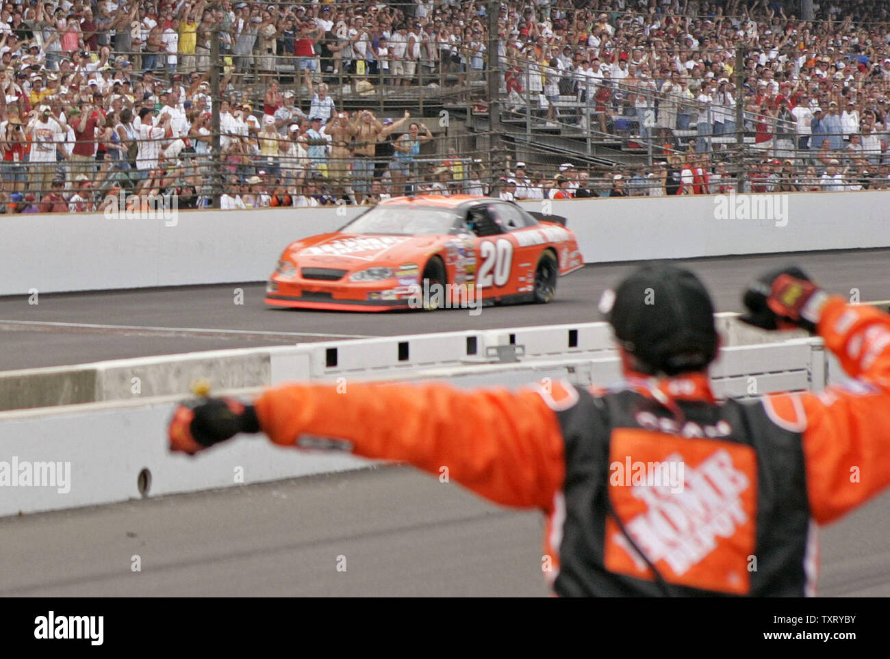 Tony Stewart crosses the finish line winning the Allstate 400 at the ...