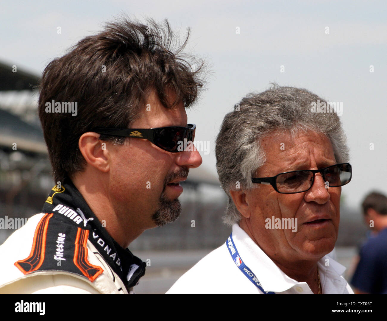Michael Andretti and his father Mario Andretti watch the monitor as ...