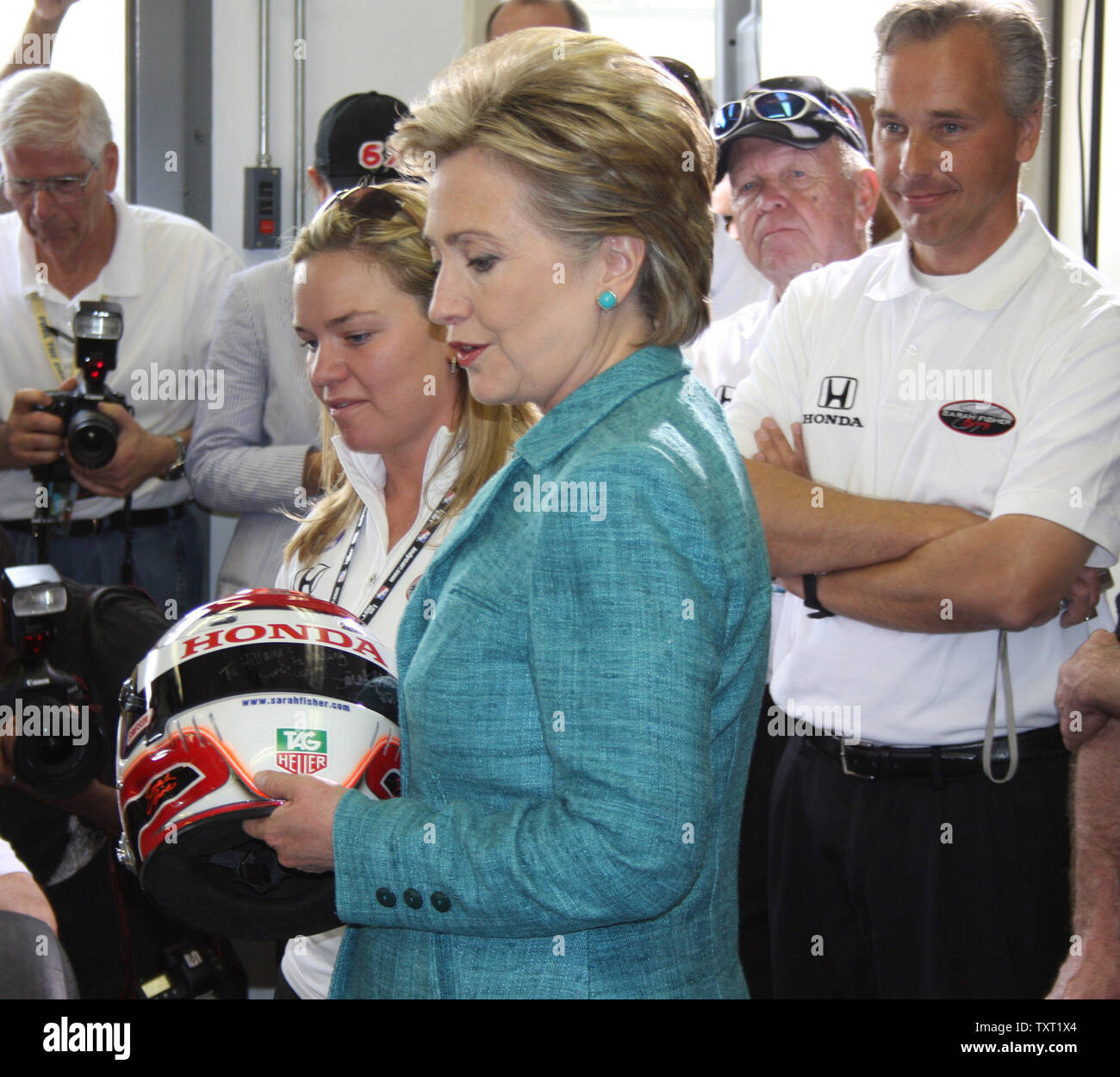 Indy 500 driver Sarah Fisher presents Hillary Clinton with one of her ...