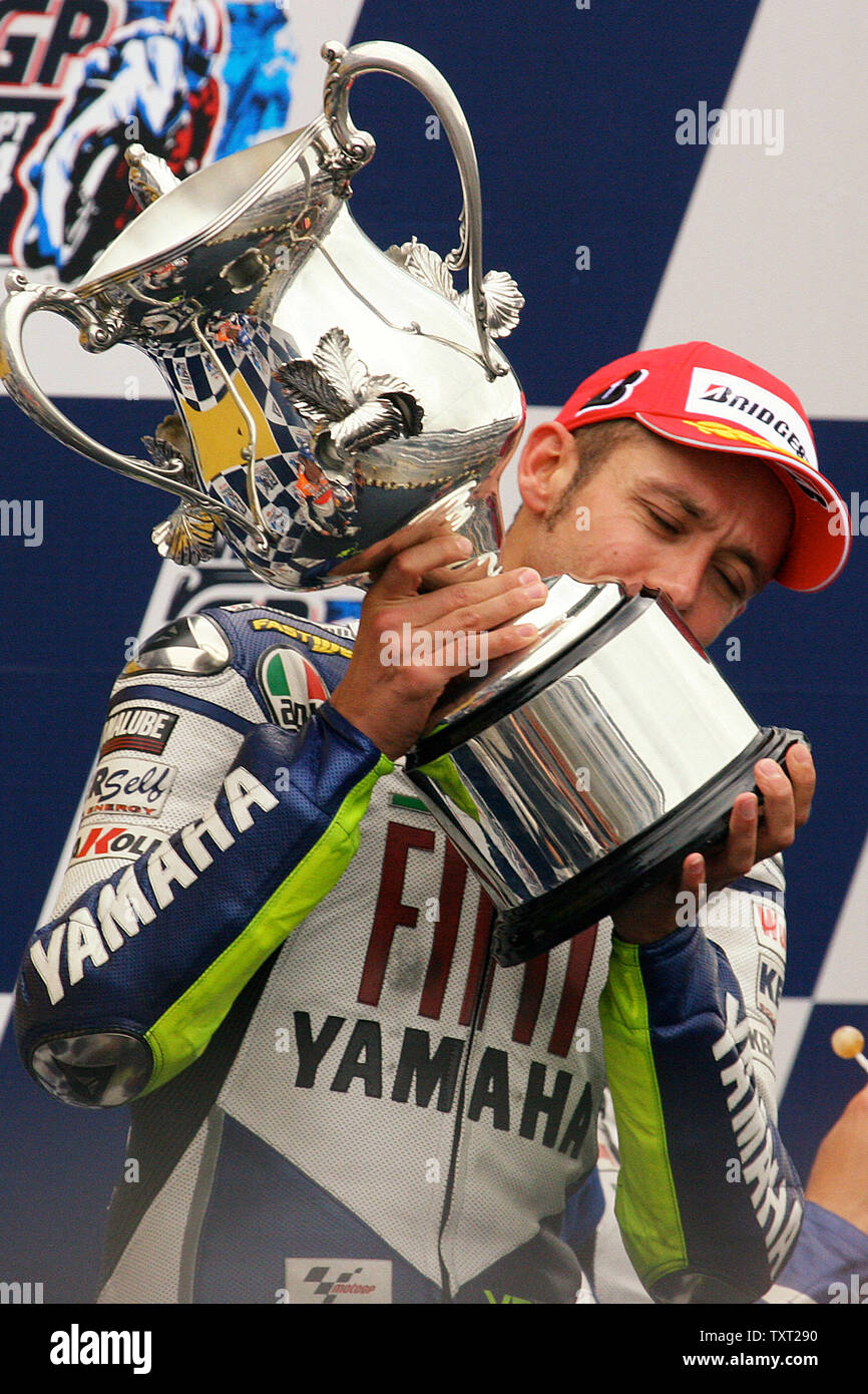 Valentino Rossi of Italy kisses his trophy after winning the rain ...