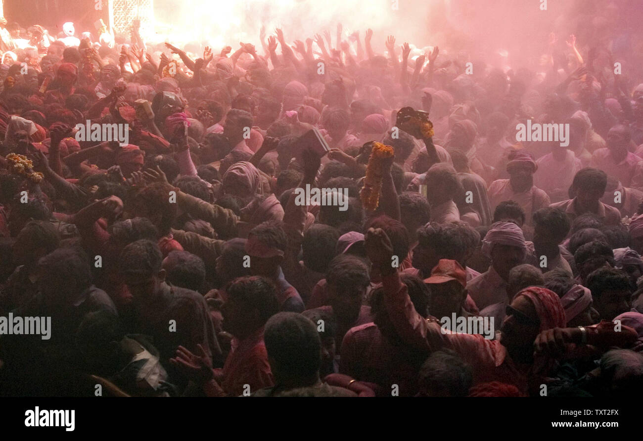 Indians throw colored powder on each other as they celebrate the Hindu ...
