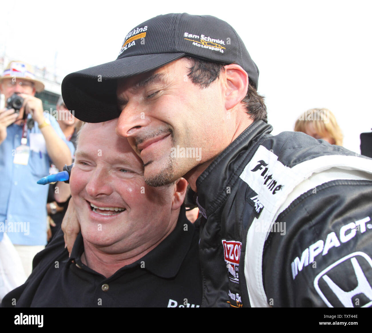 Alex Tagliani hugs his team owner Sam Schmidt after winning the Pole ...