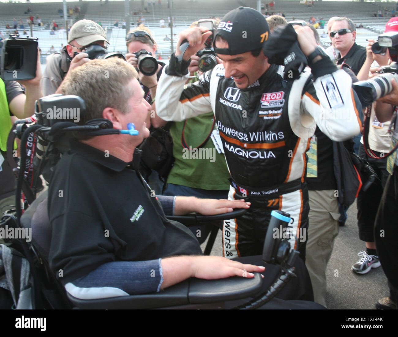 Car owner Sam Schmidt celebrates with his driver Alex Tagliani after ...