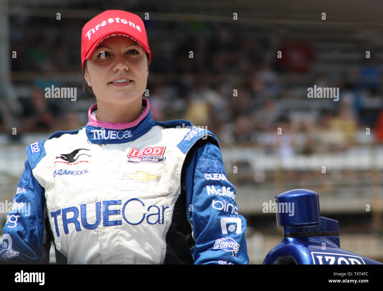 Rookie Katherine Legge happily poses with her car after qualifying in ...