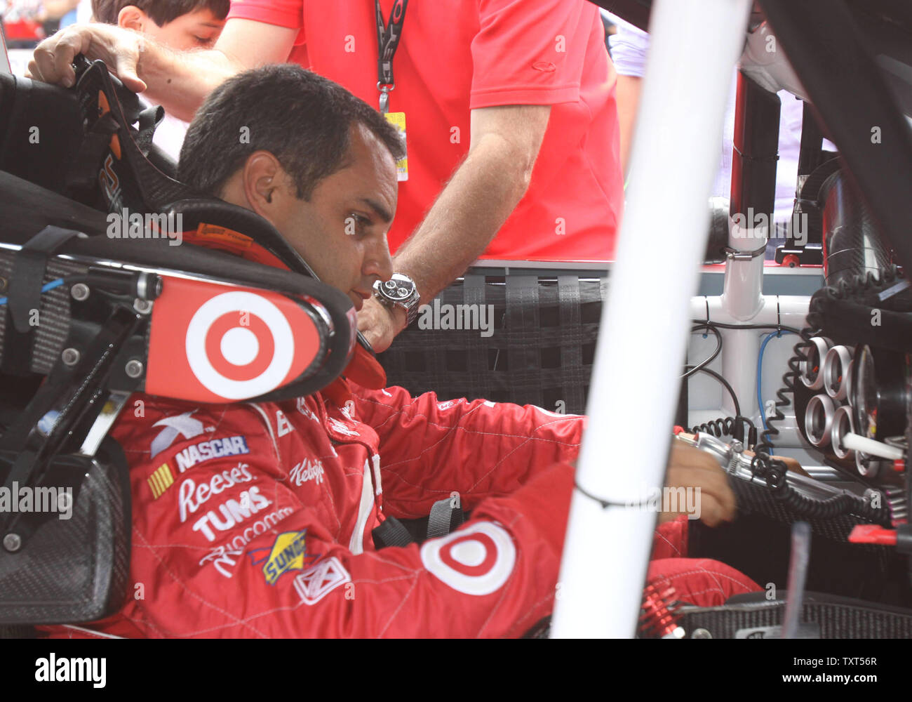 Juan Pablo Montoya gets strapped into his car before the running of the ...