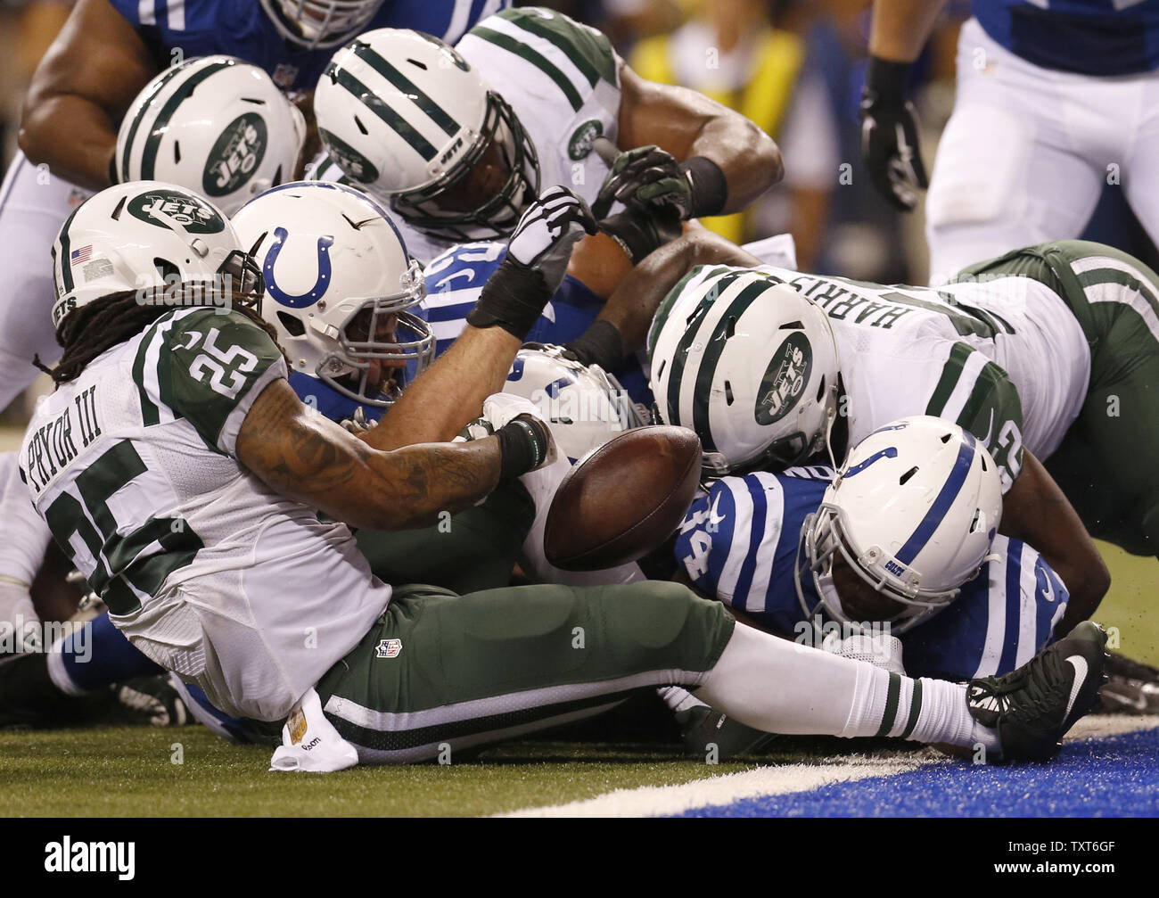 New York Jets' Jalil Brown (25) strips the football loose from ...
