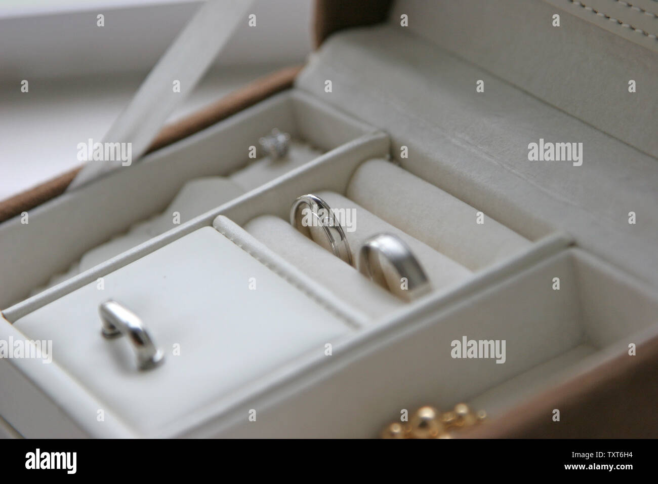 Inside of jewellery box displaying bride and groom's wedding rings ...