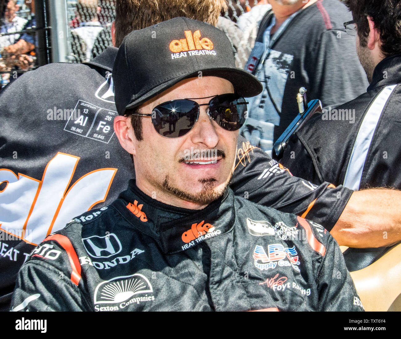 Veteran driver Alex Tagliani walks to his race car to begin practice ...