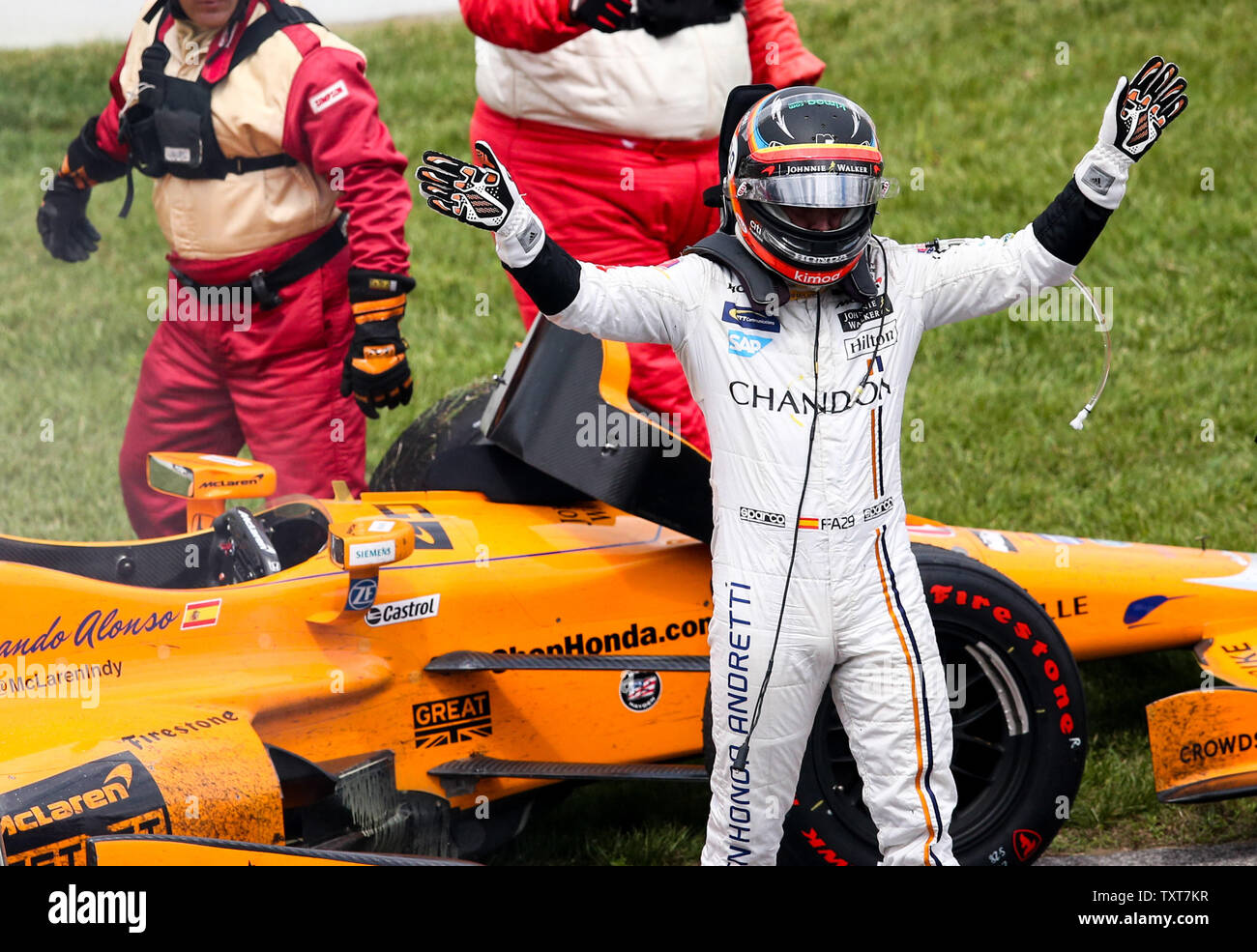 Fernando Alonso acknowledges the turn one crowd after his engine failed ...
