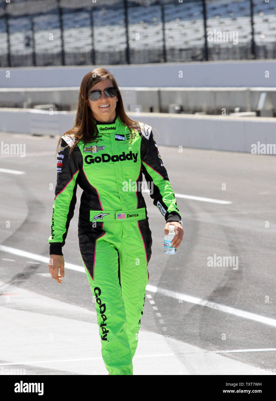 Danica Patrick walks through the pit area to her race car to begin a ...