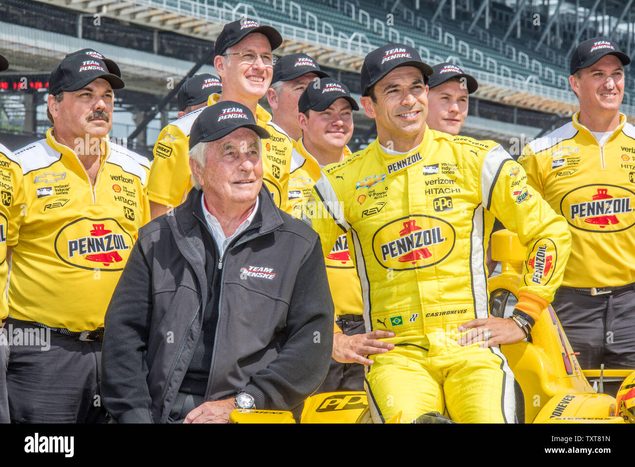 Roger Penske (sitting left) poses with Helio Castroneves after ...