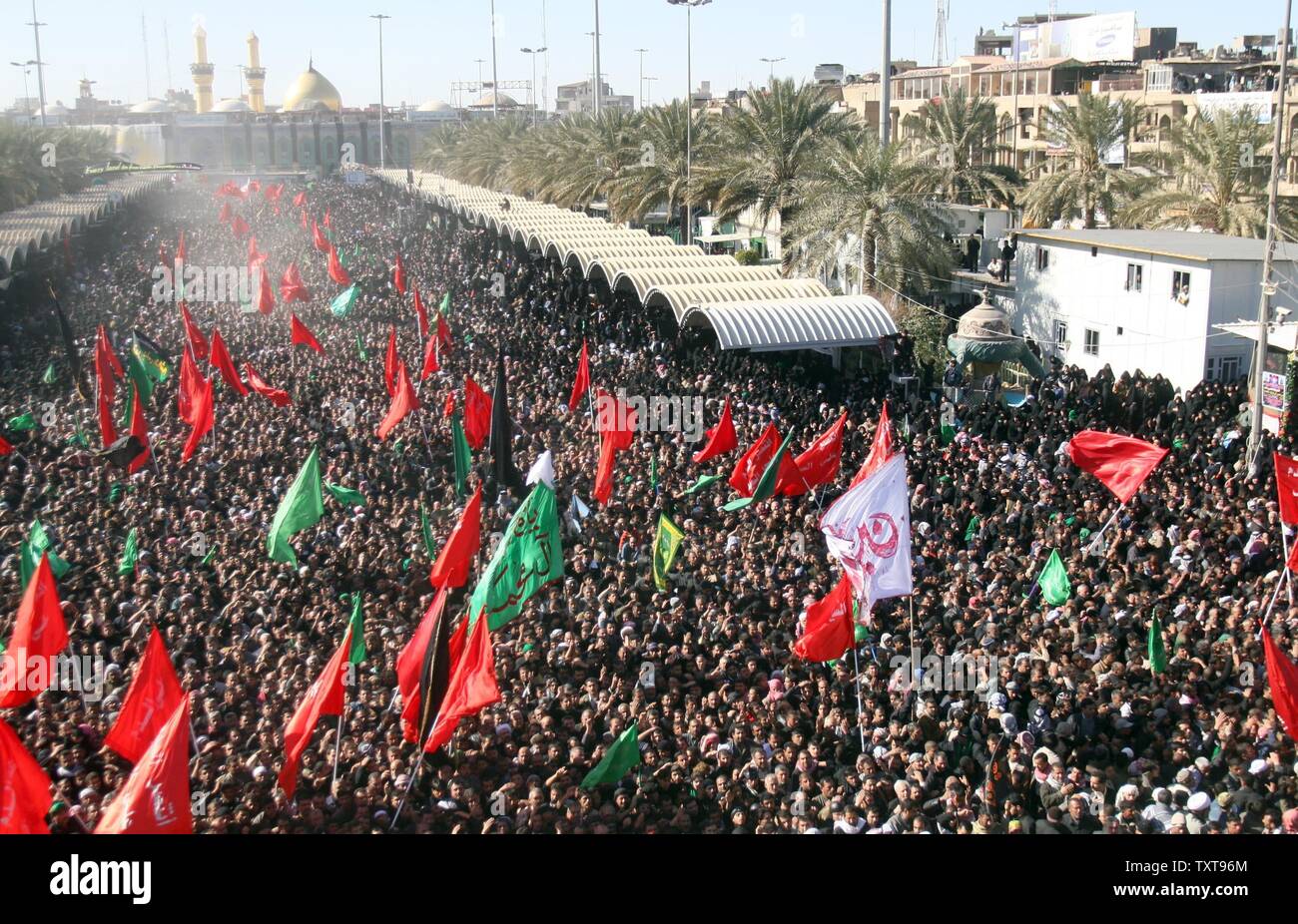 Thousands of pilgrims wave Shiite flags during the climax of the ...