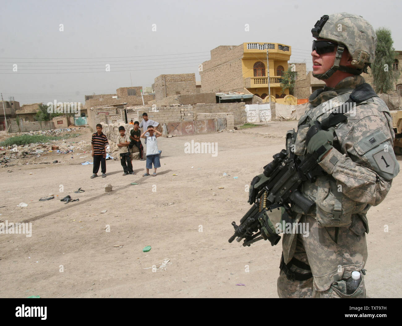 U.S. army soldiers stand alongside their Iraqi counterparts as they ...