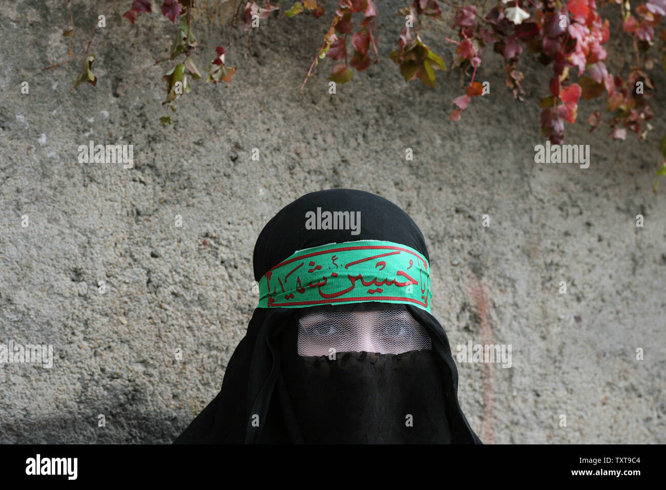A woman wears a chador at the during an Islamic mourning ceremony ...