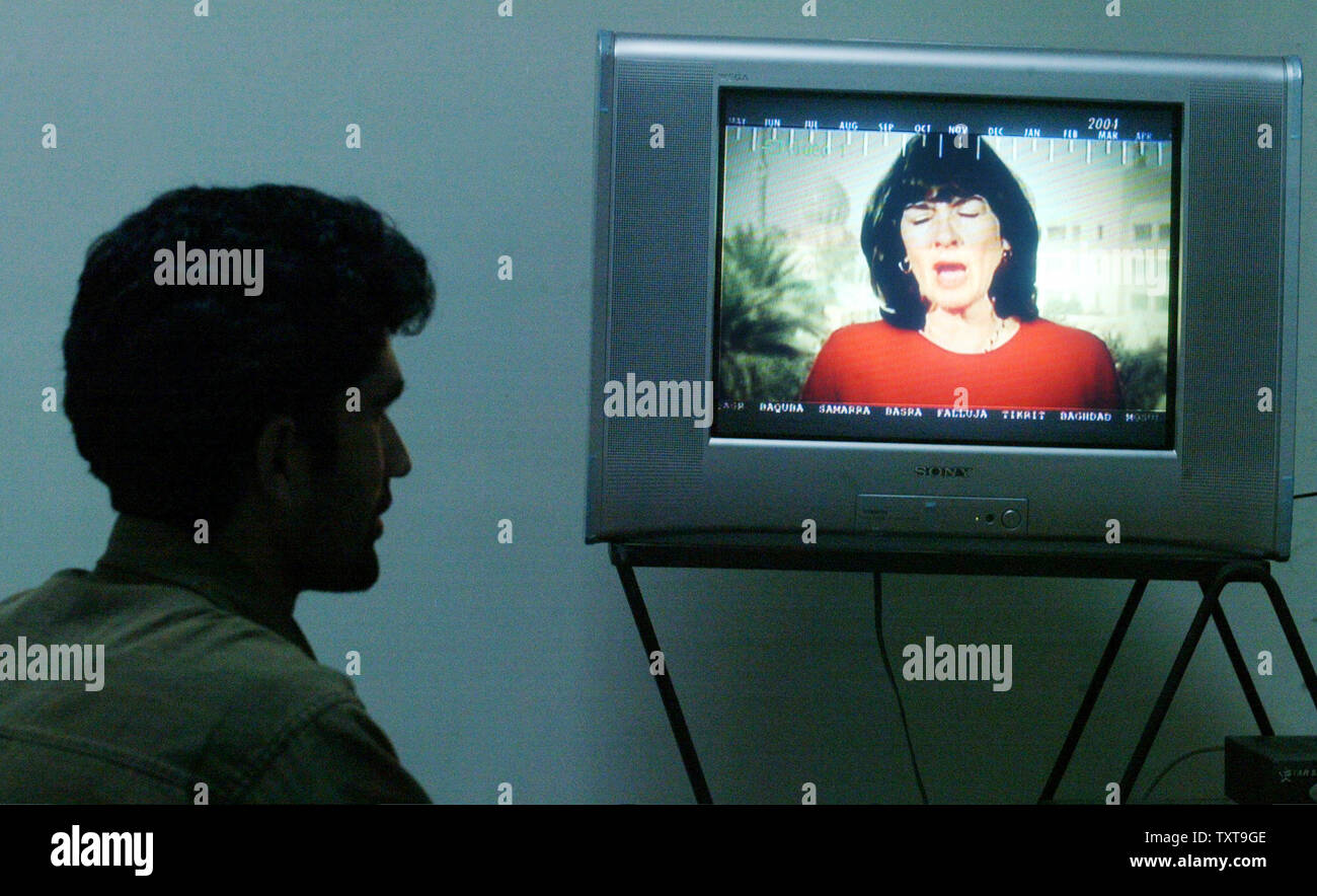 An Iranian journalist watches the CNN news channel in Tehran, Iran on ...