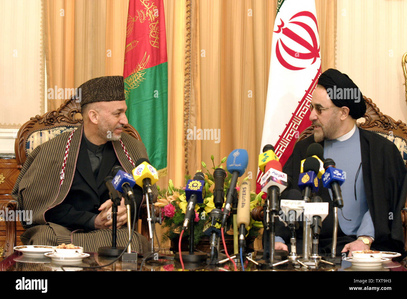 Iranian President Mohammad Khatami (R) and his Afghan counterpart Hamid ...
