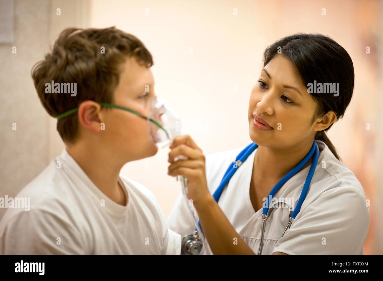 Doctor puts oxygen mask on young patient Stock Photo - Alamy