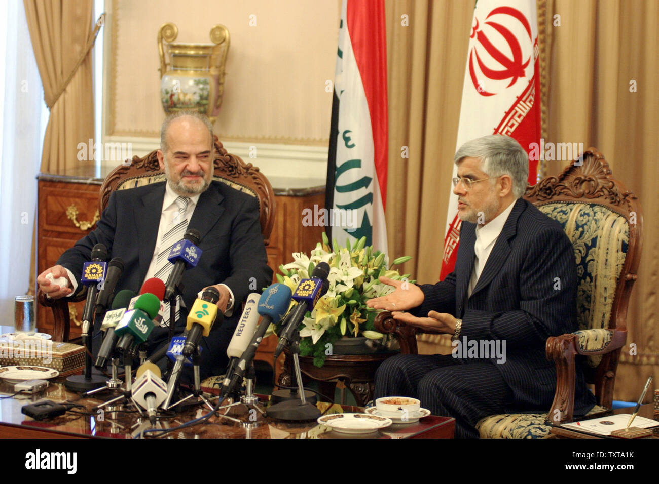 Iranian First Vice-President Mohammad Reza Aref (R) talks with visiting ...