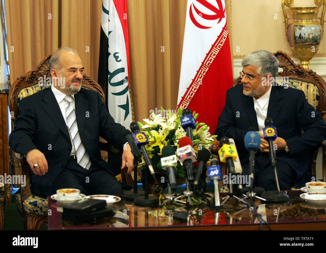 Iranian First Vice-President Mohammad Reza Aref (R) talks with visiting ...
