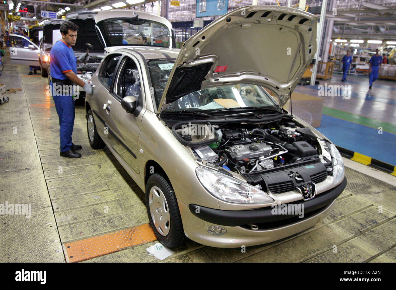 Workers of Iran Khodro work on an assembly line producing Iran's ...