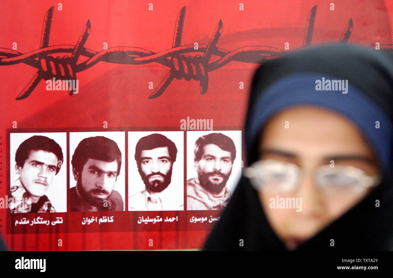 An Iranian student holds portraits of missing Iranian diplomats and a ...
