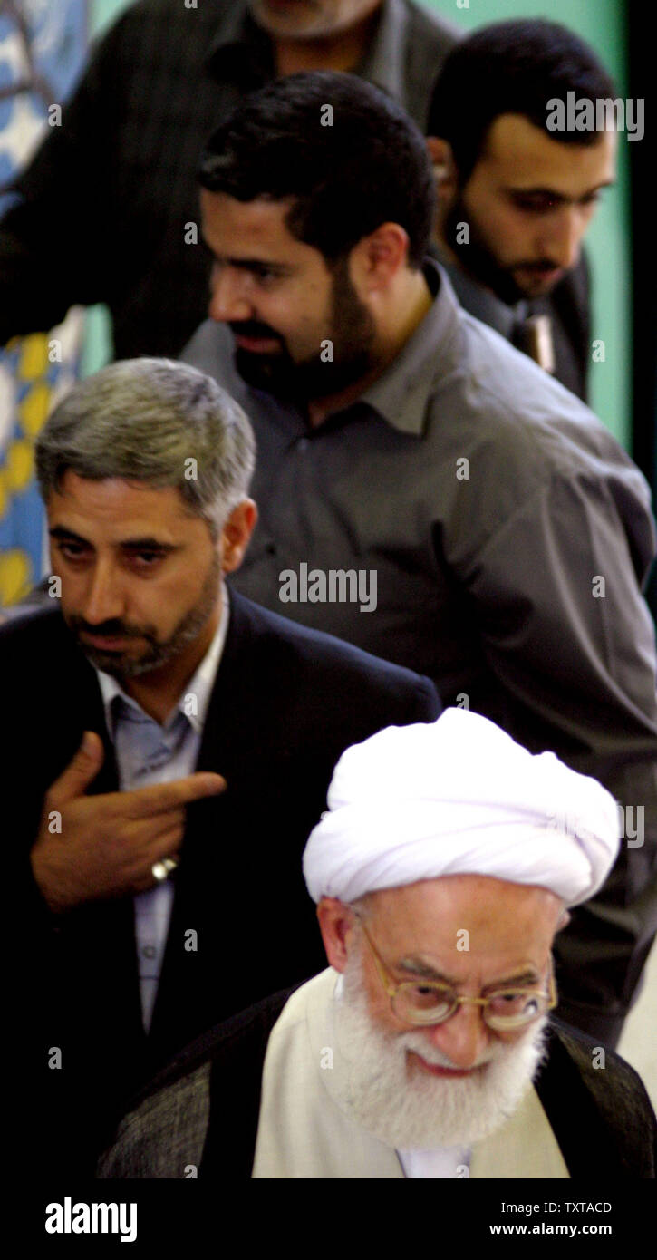 Top Iranian cleric Mohammad Emami Kashani (bottom) stands between his ...