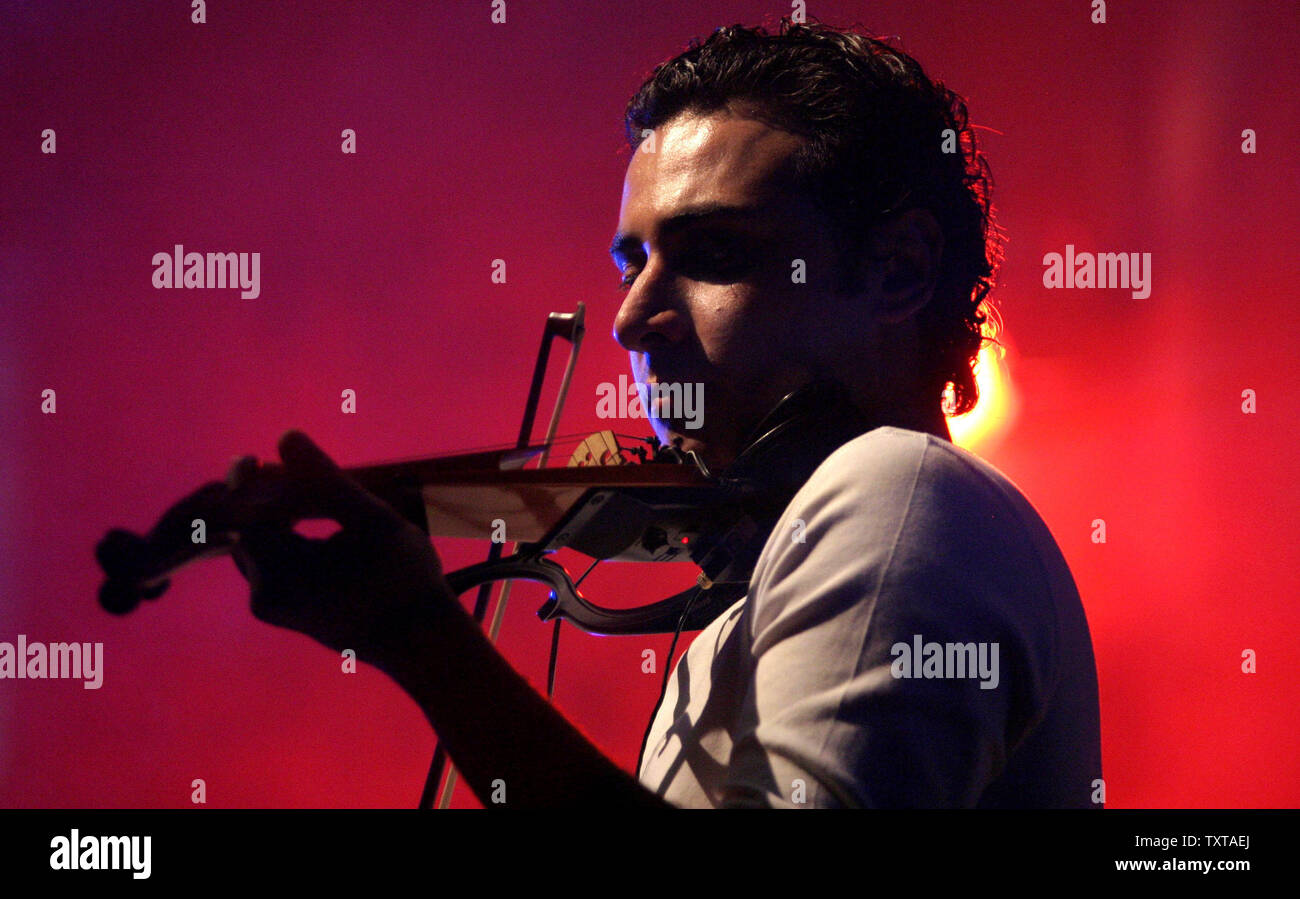 Siamak Khahani, part of the nine-member Arian band, plays guitar near ...