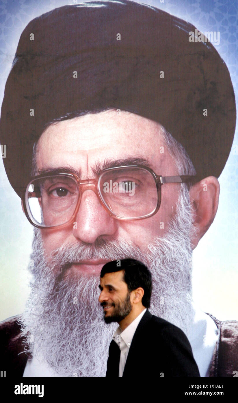 Iran's president Mahmoud Ahmadinejad makes his way in front of a poster ...