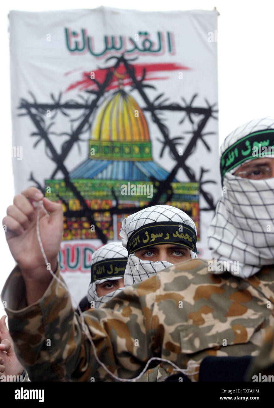 Iranian Basij, famous as Al-Esteshhadion, stand below a Al-Aghsa mosque ...