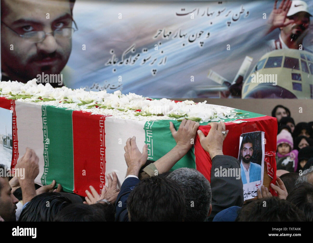 Iranian people carry the casket of Fars News Agency photographer , Ali ...