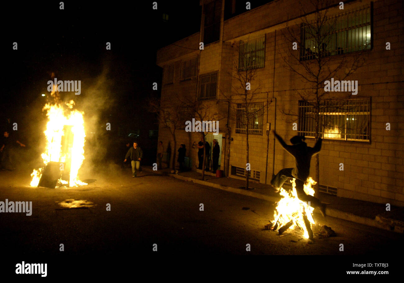 An Iranian young woman jumps over a fire during a ceremony celebrating ...
