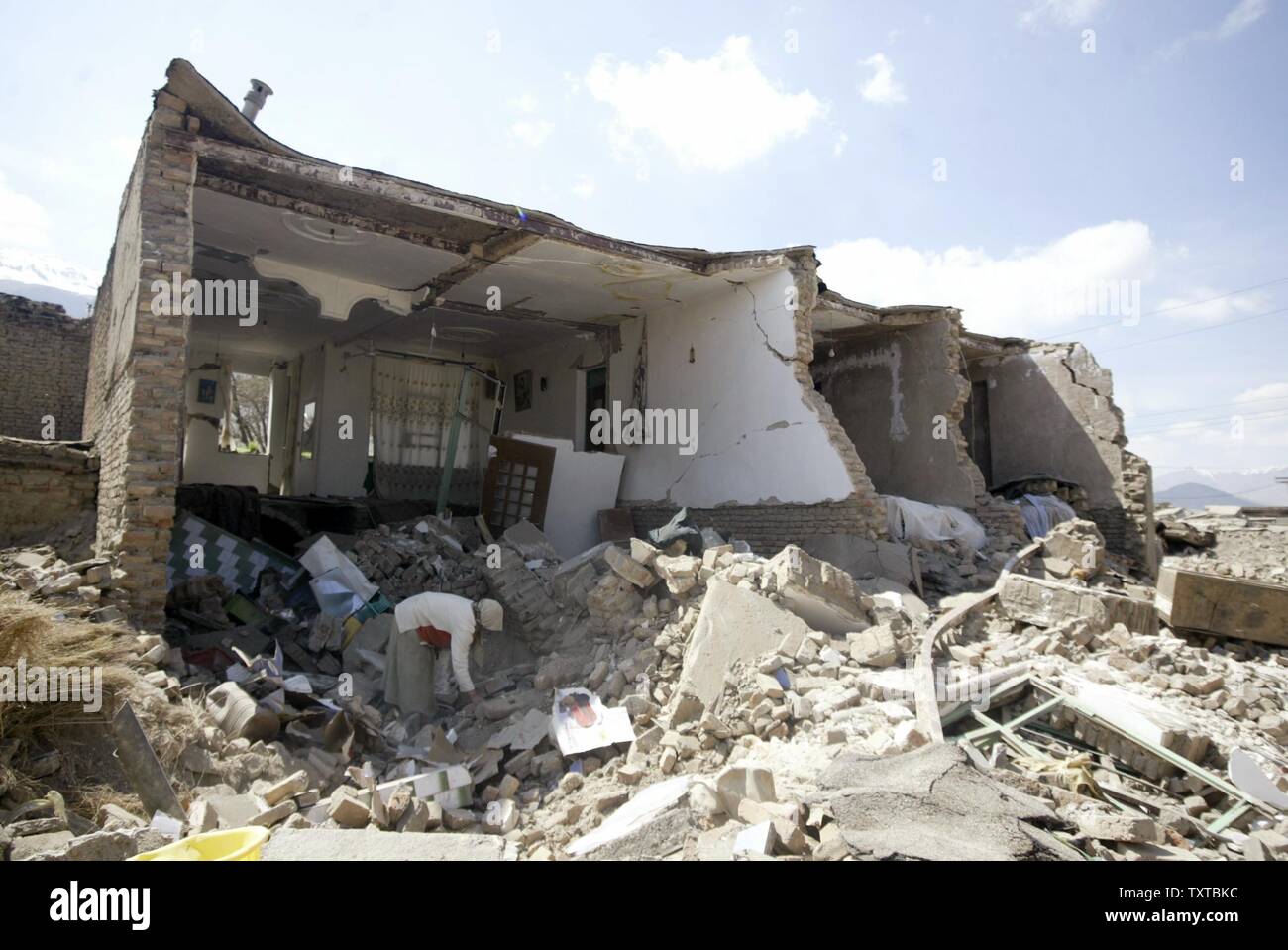 Iranians search among rubble after an earthquake in their village ...