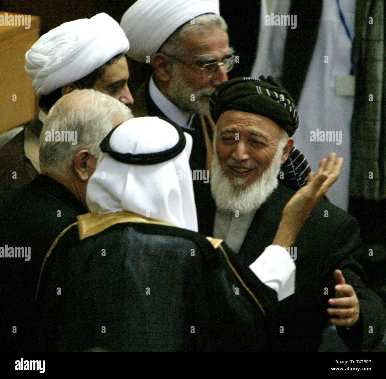 Former president of Afghanistan Burhanuddin Rabbani (R) greets a man ...