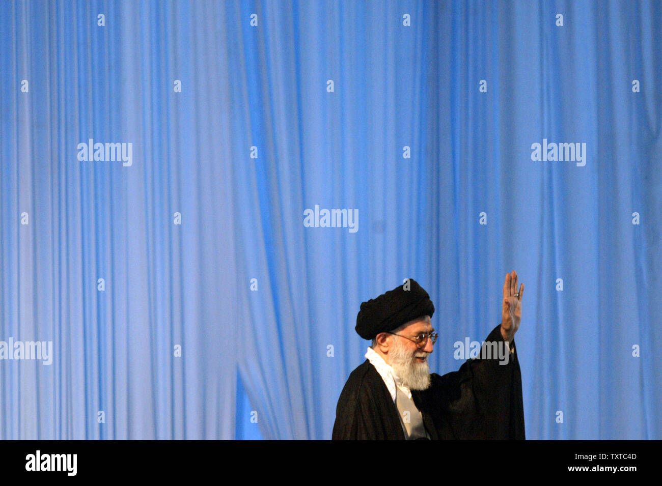 Iran's supreme leader Ayatollah Khamenei waves his hand as he attends a ...