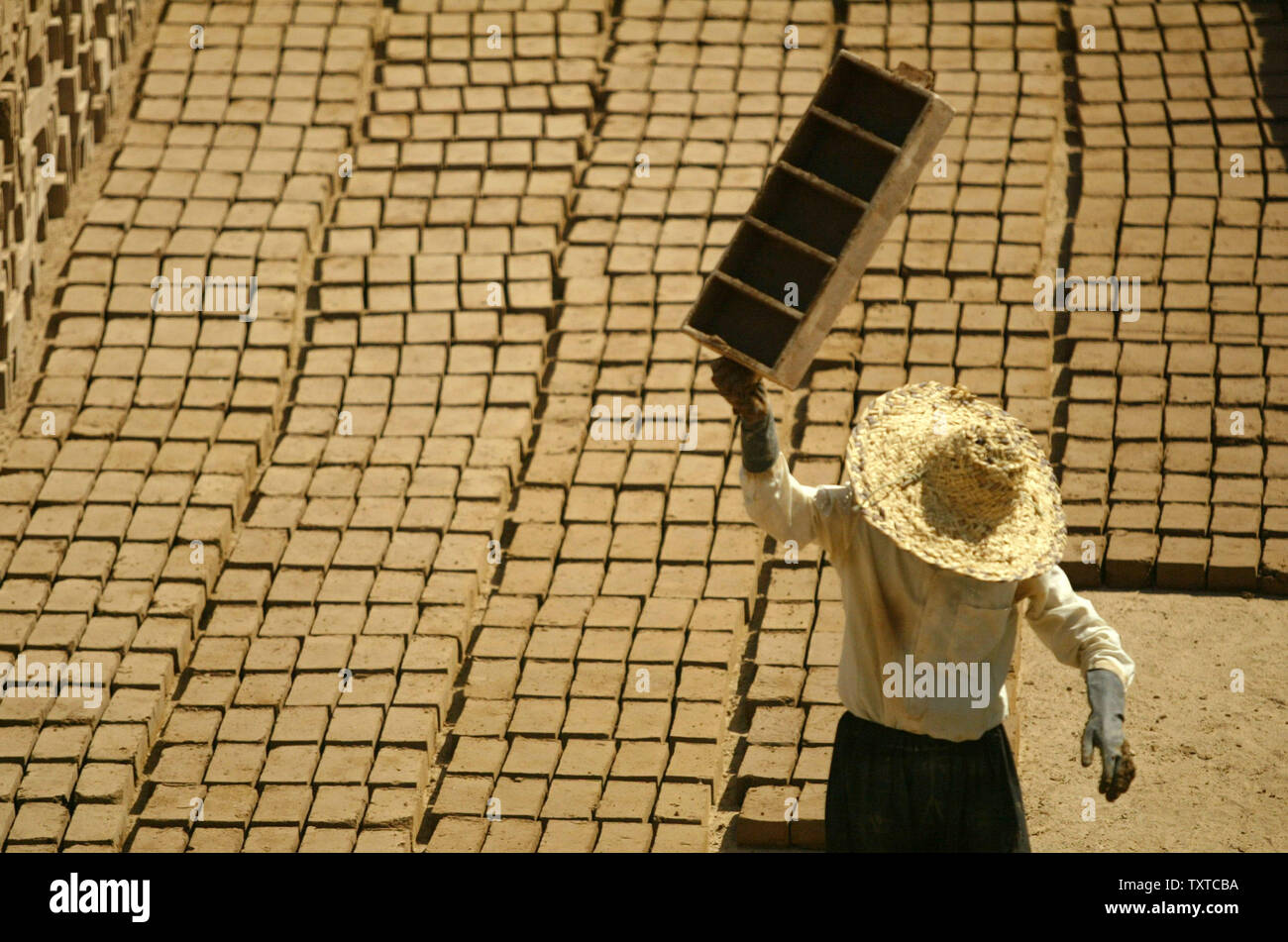 An Iranian brick burner works in one of the brickyards in Pakdasht ...