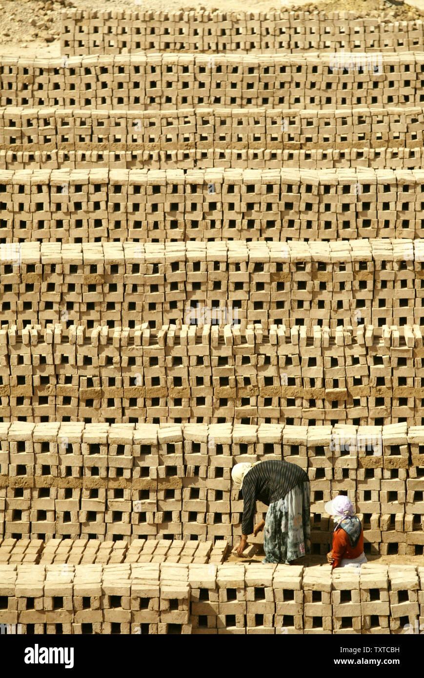 Iranian brick burners work in one of the brickyards in Pakdasht, just ...