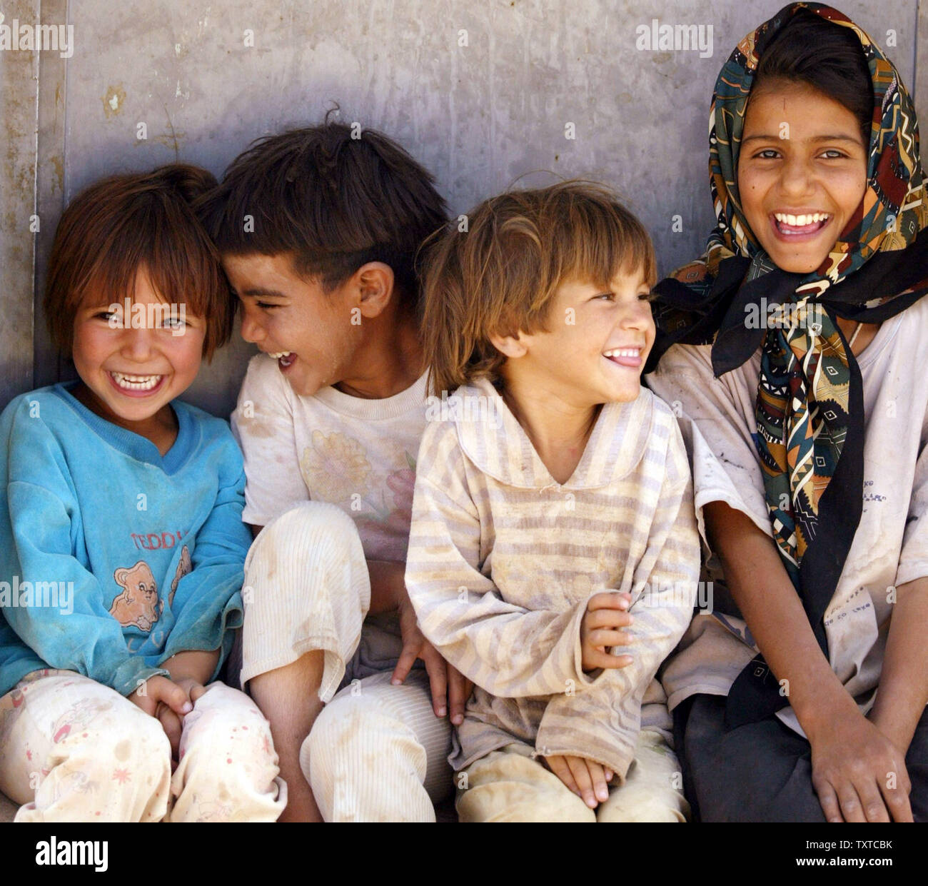 Children of Iranian brick burners laugh as they are photographed in one ...