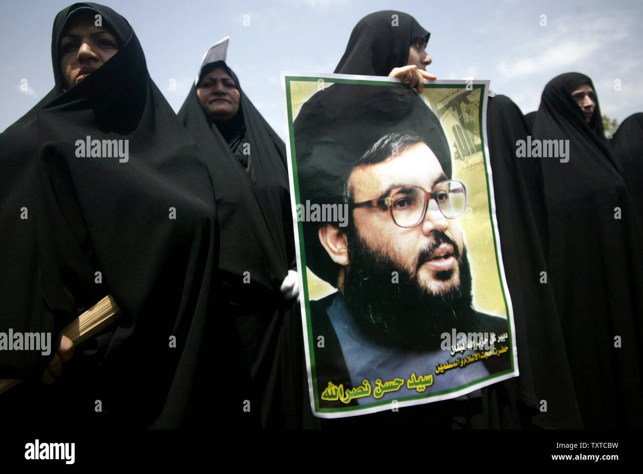Iranian women hold pictures of Hezbollah chief Sayyed Hassan Nasrallah ...