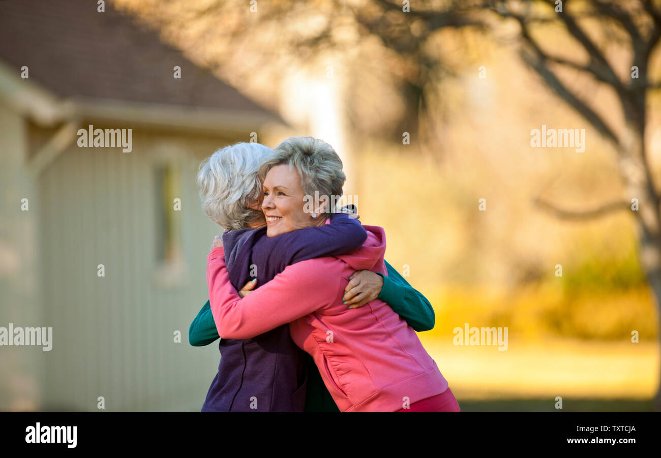 Three senior women hugging each other in a park Stock Photo - Alamy
