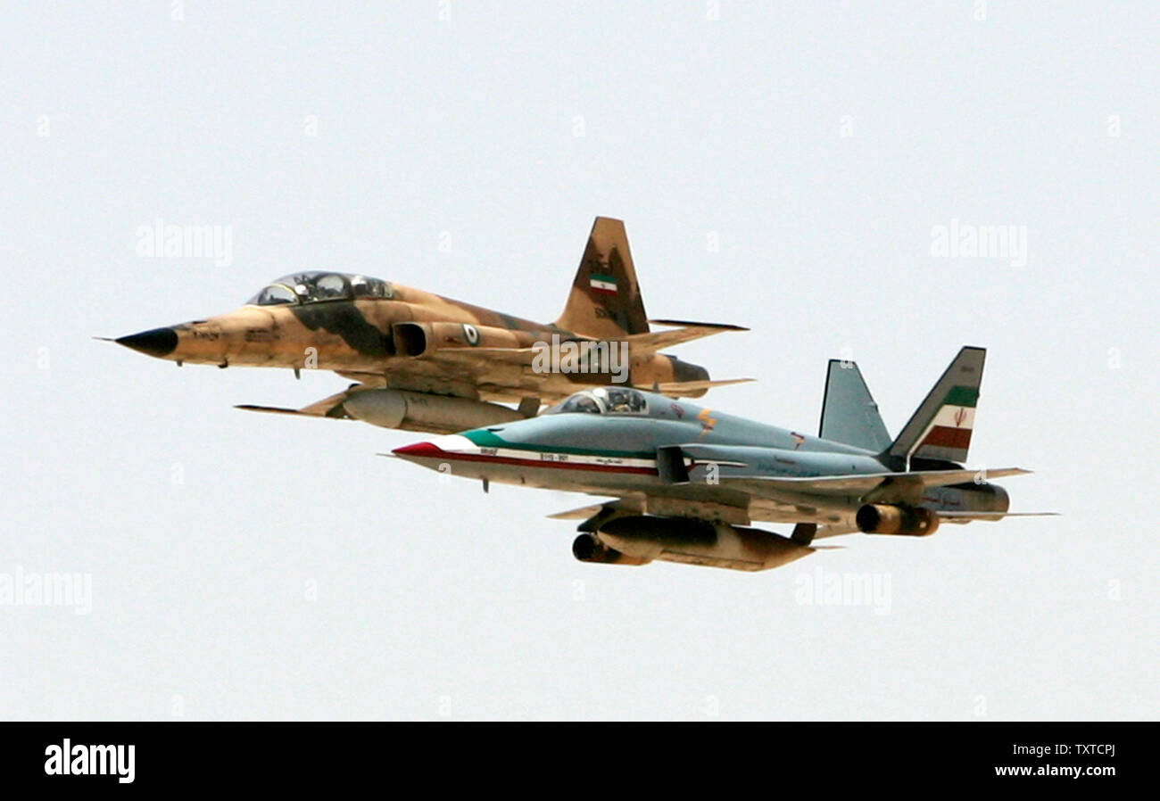 An Iranian Saegheh (Thunder) jet fighter (R) flies during air maneuvers ...