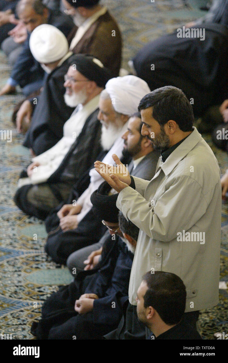 Iran's President Mahmoud Ahmadinejad (R) prays during weekly Friday ...