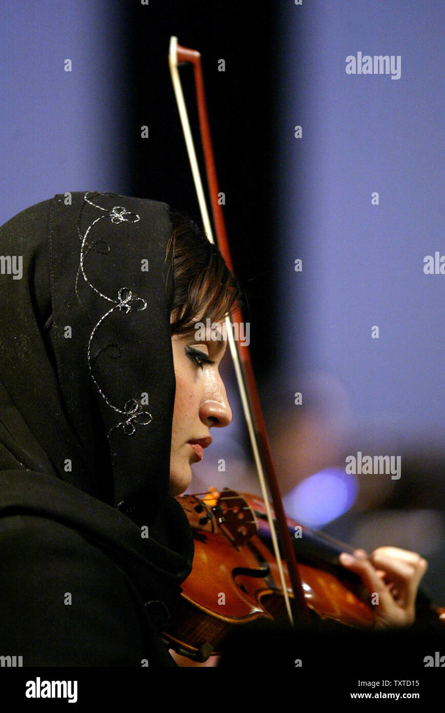 An Iranian musician performs during the symphony orchestra of the 21st ...