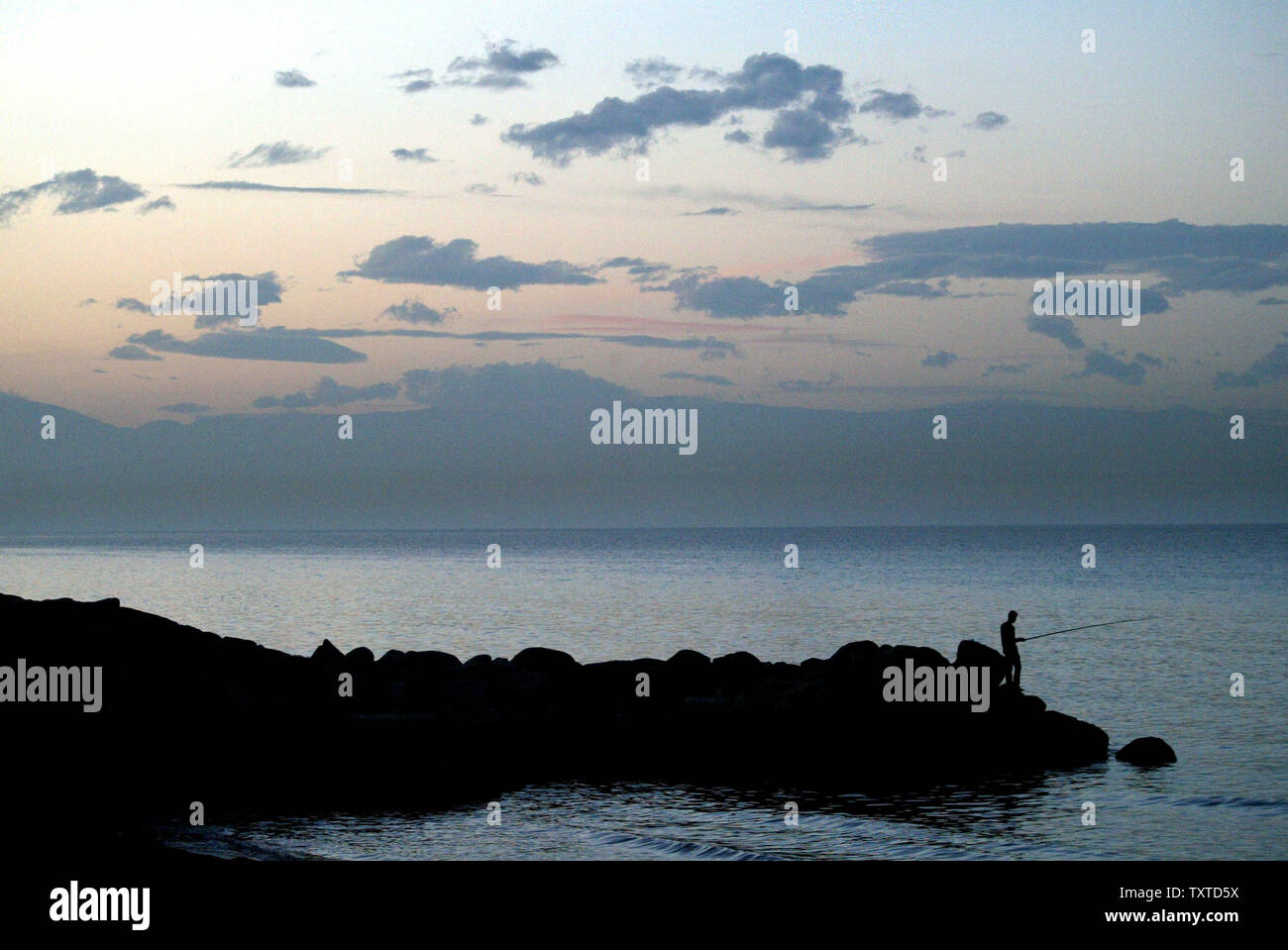 An Iranian hobby fisherman tries his luck during sunset in Caspian Sea ...