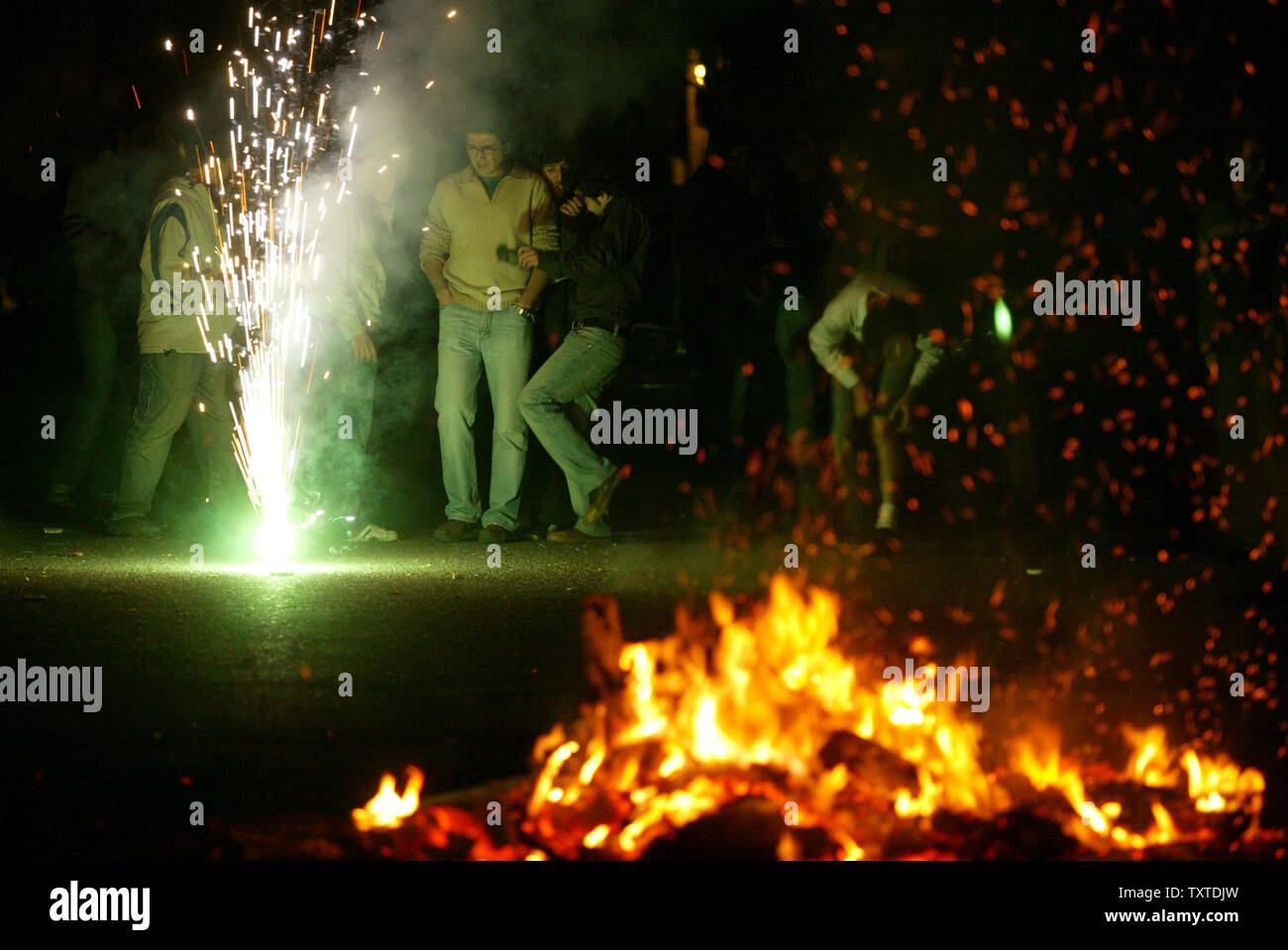 Iranians play with firecrackers during a ceremony celebrating the last ...